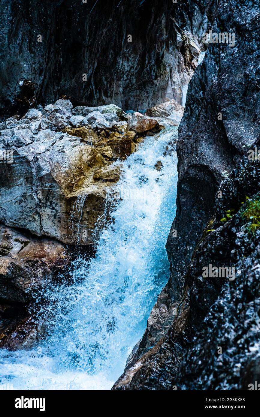 Closeup of a waterfall with strong current between rocky cliffs Stock ...