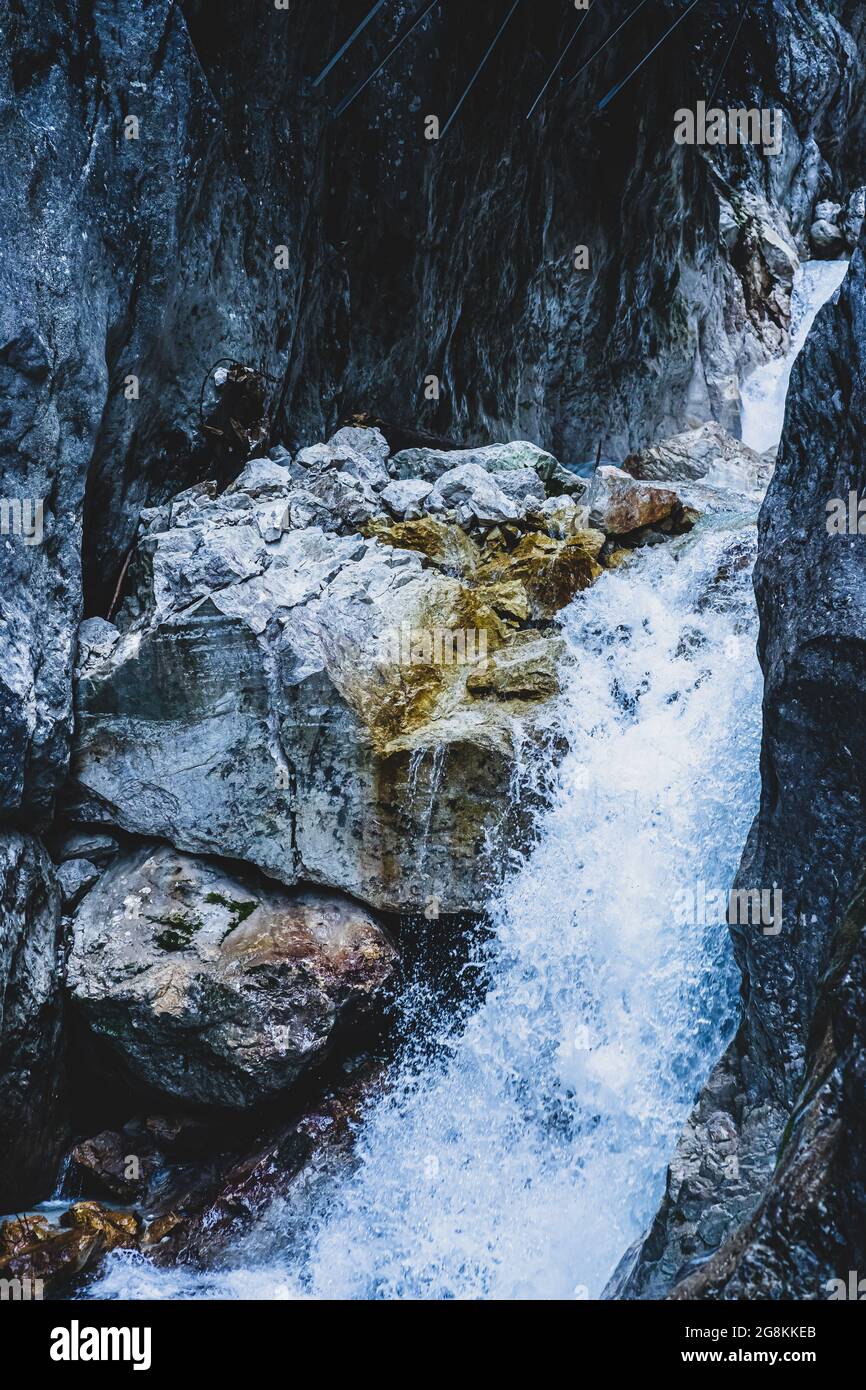 Closeup of a waterfall with strong current between rocky cliffs Stock ...