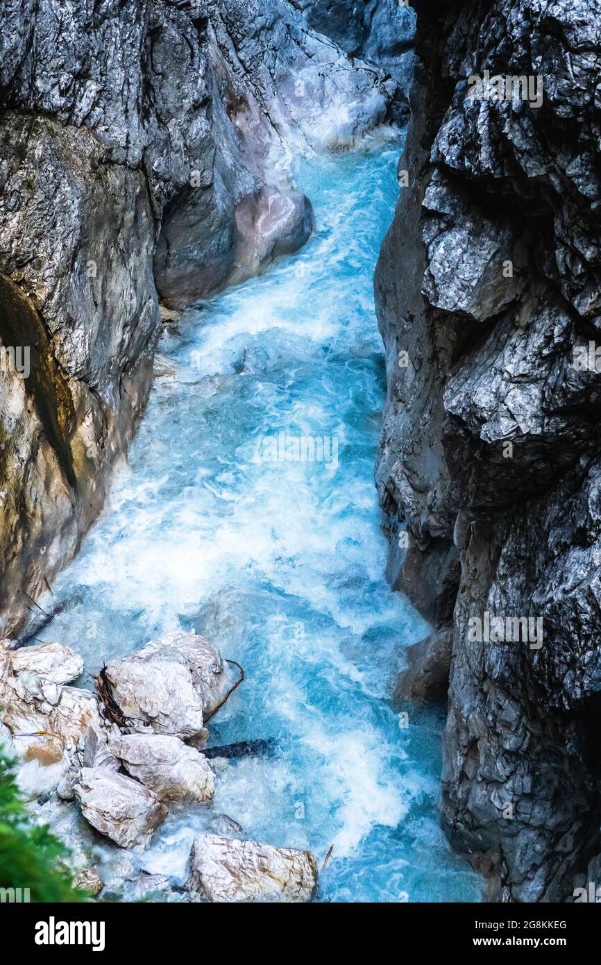 Scenic view of a river with clear blue water flowing among boulders and ...