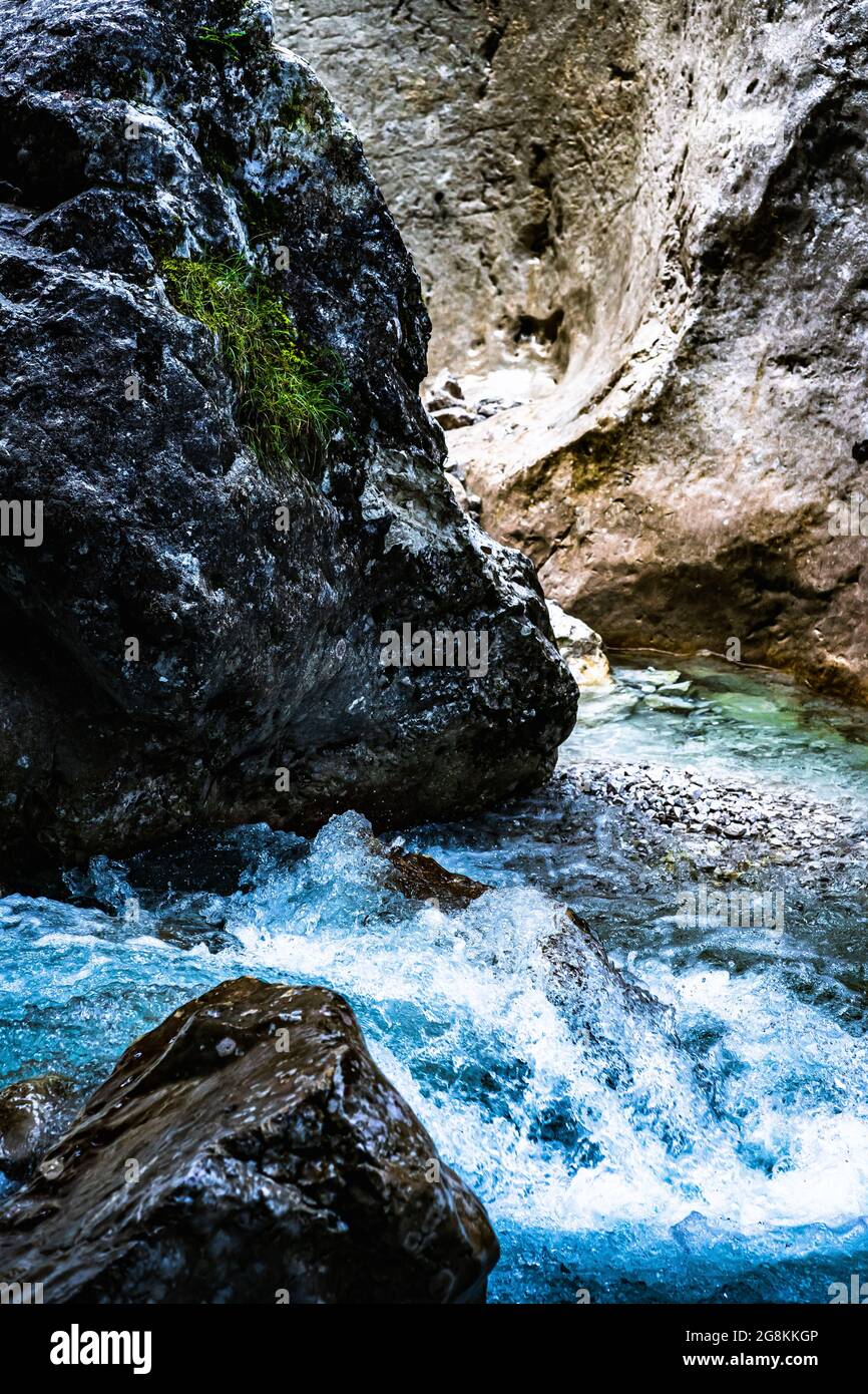 Scenic view of a river with clear blue water flowing among boulders and ...