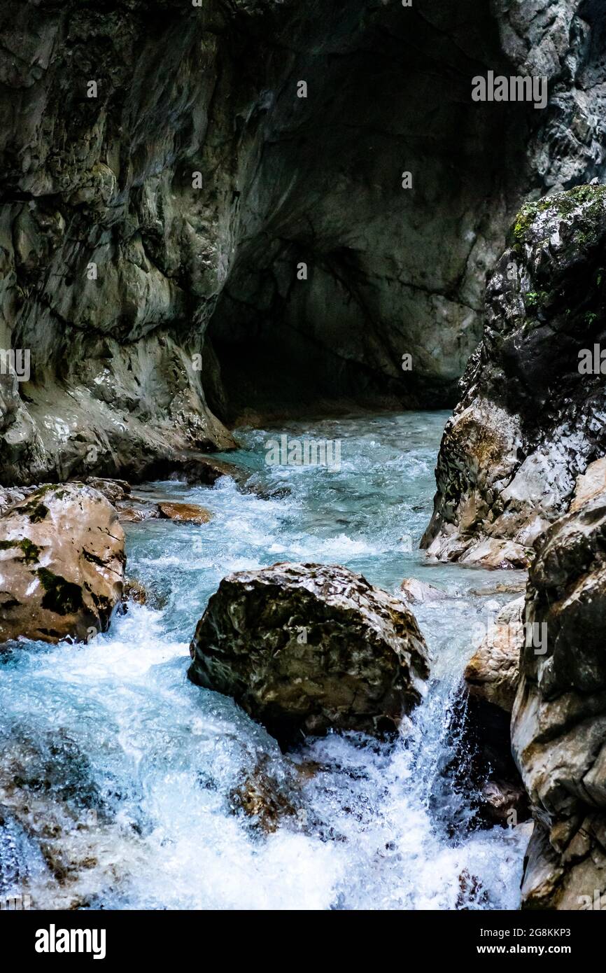 Scenic view of a river flowing among boulders and between rock cliffs ...