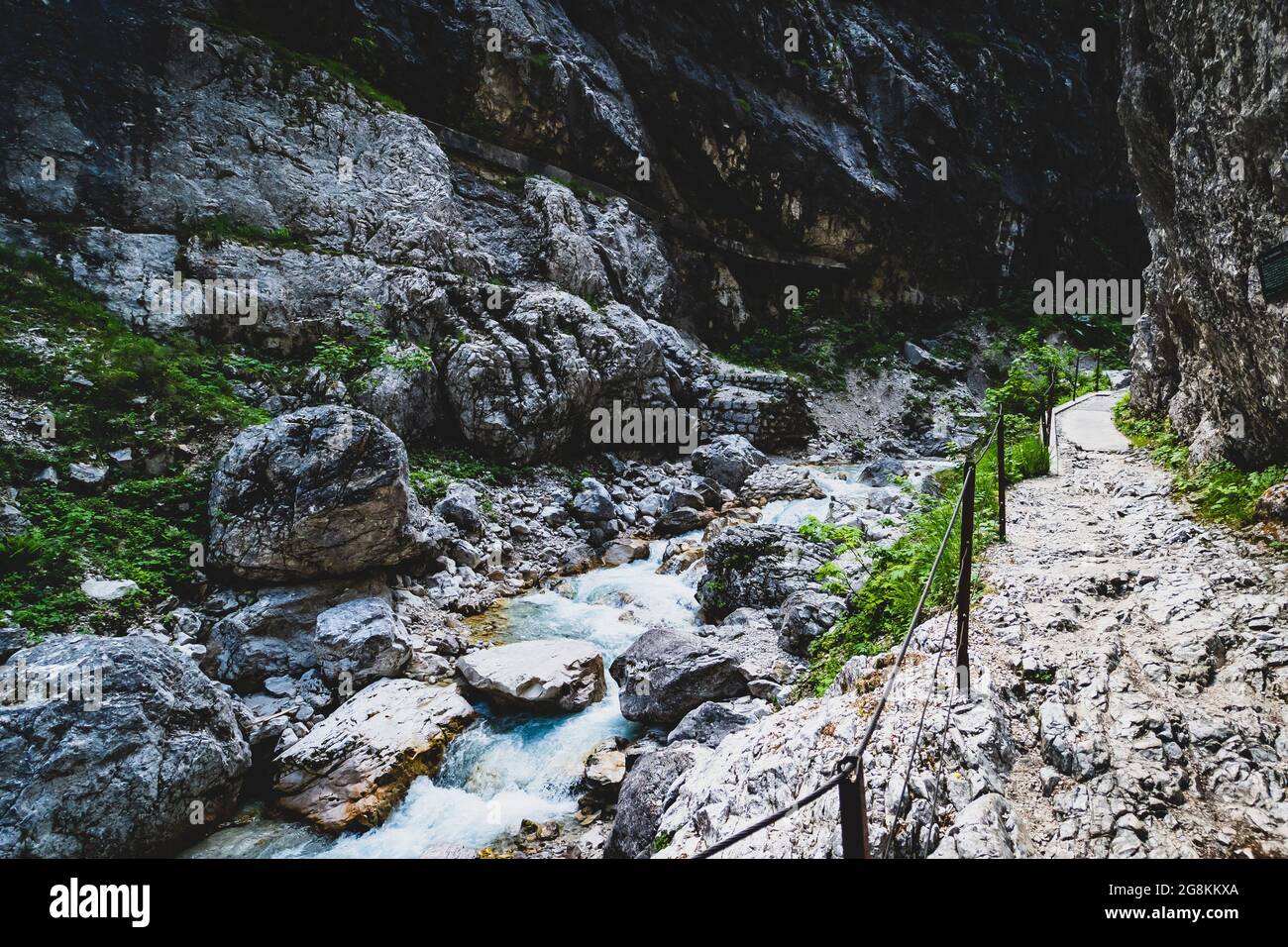 Scenic view of a river flowing among boulders and between rock cliffs ...