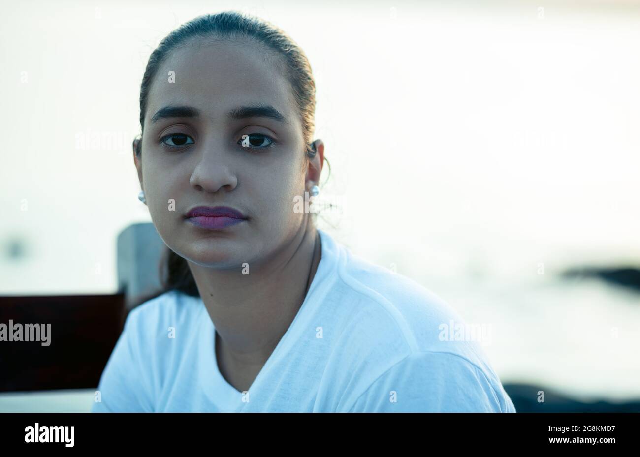 Closeup of a pretty young Hispanic female with a serious look Stock ...