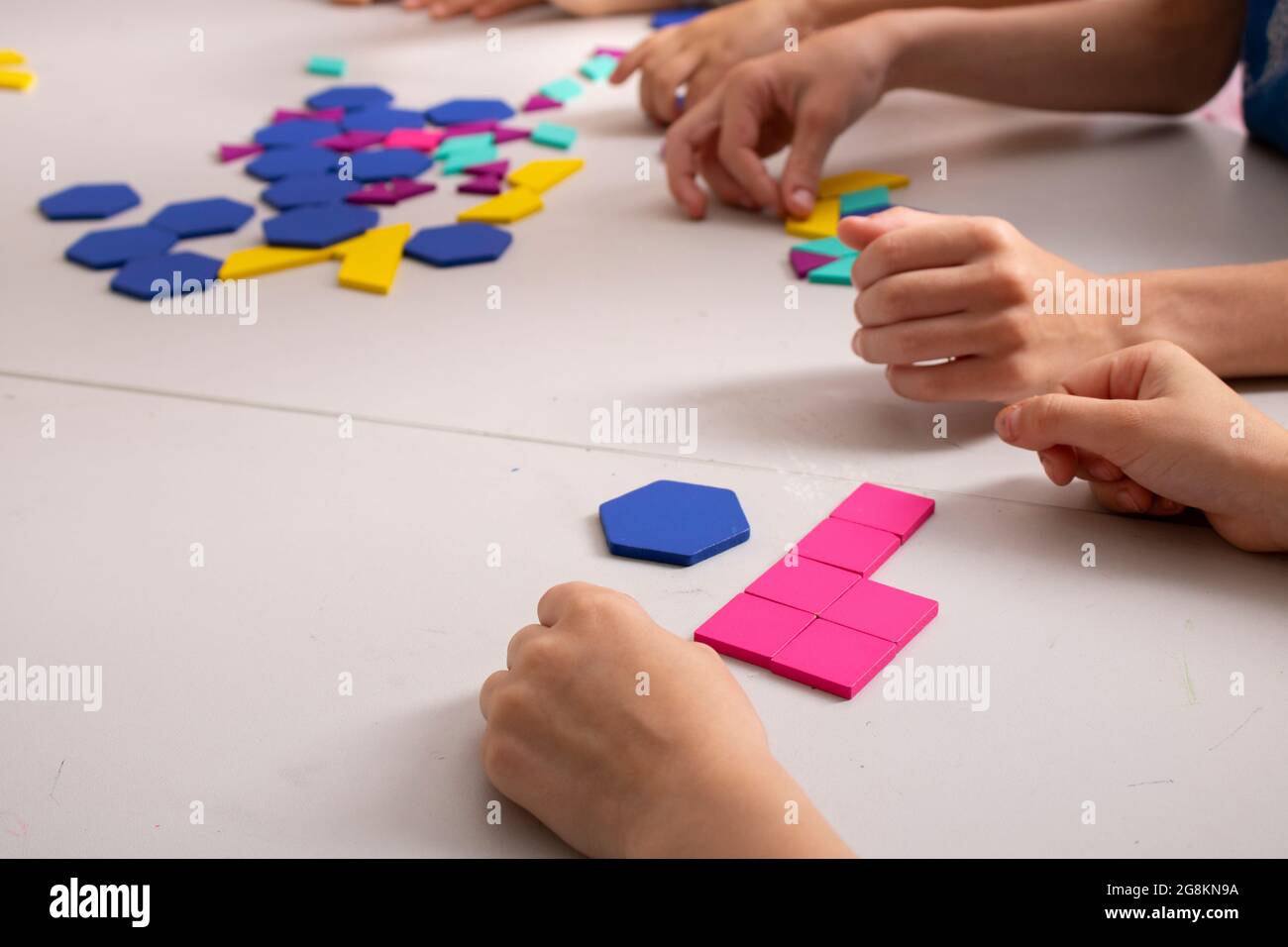 Logic game concept. Kids playing with colorful bricks Stock Photo - Alamy