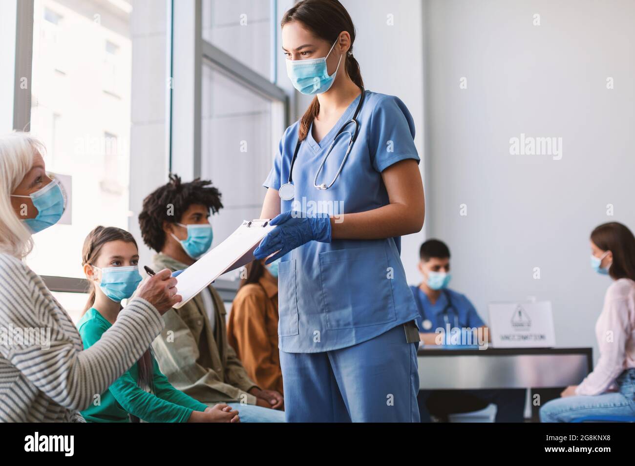 Mature Patient Lady Signing Papers With Doctor In Hospital Stock Photo ...