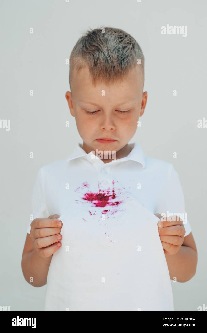 Sad boy showing dirty clothes on himself. concept of bleaching and ...