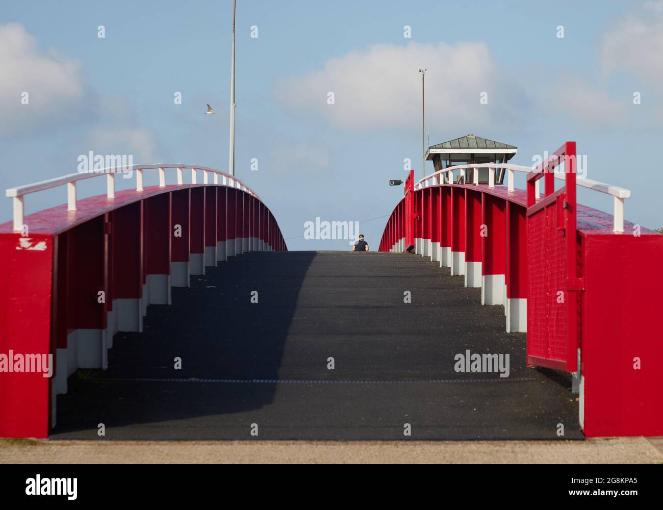 Red foot and bicycle bridge seen in Littlehampton, West Sussex, England ...