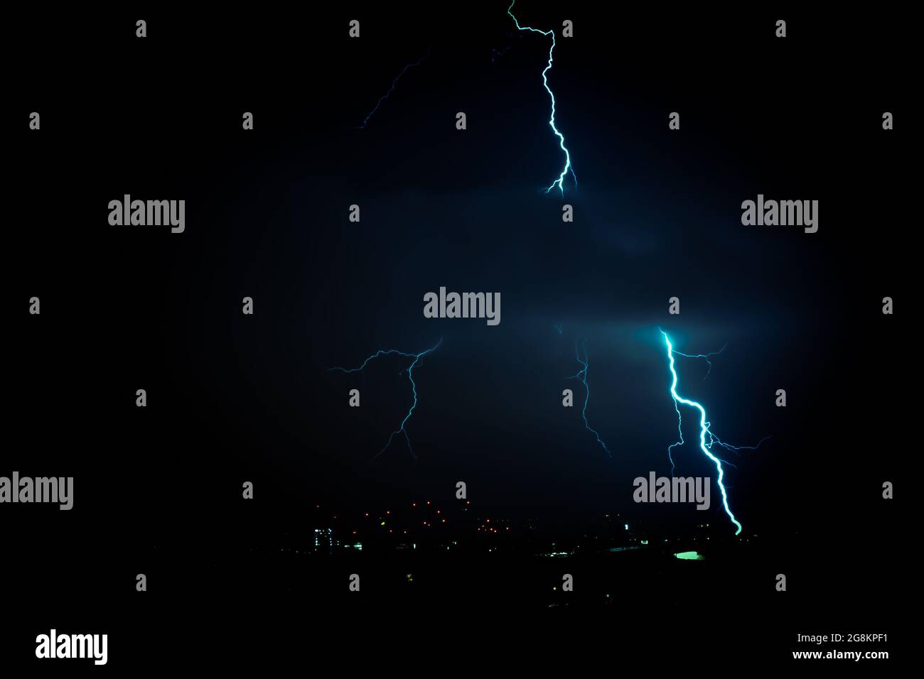 Strong lightning strike above a town at night - perfect for wallpapers ...