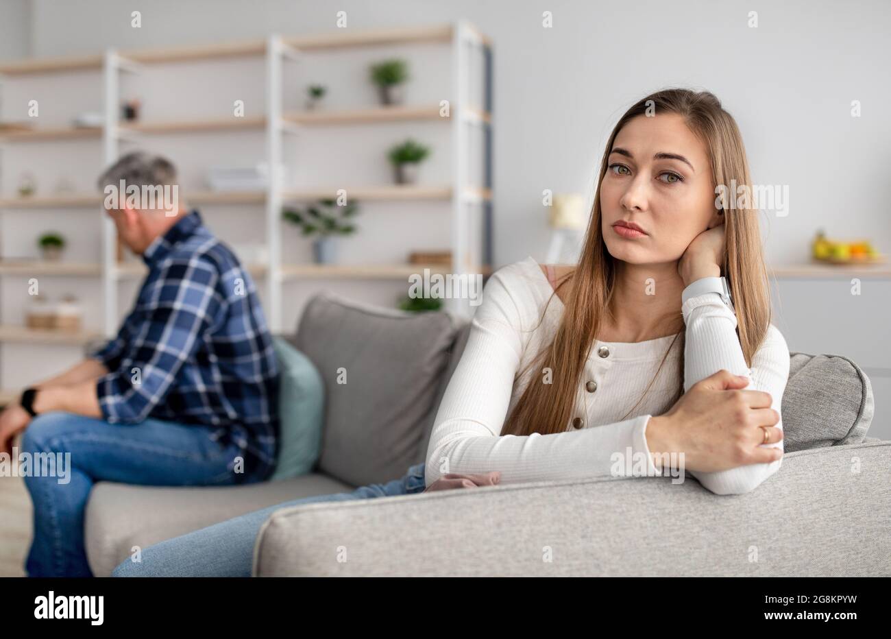 Mature Couple Sitting On Couch After Quarrel Feeling Offended Not