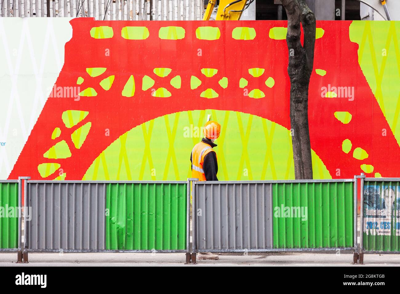 Construction worker in front of a poster representing the foot of the ...