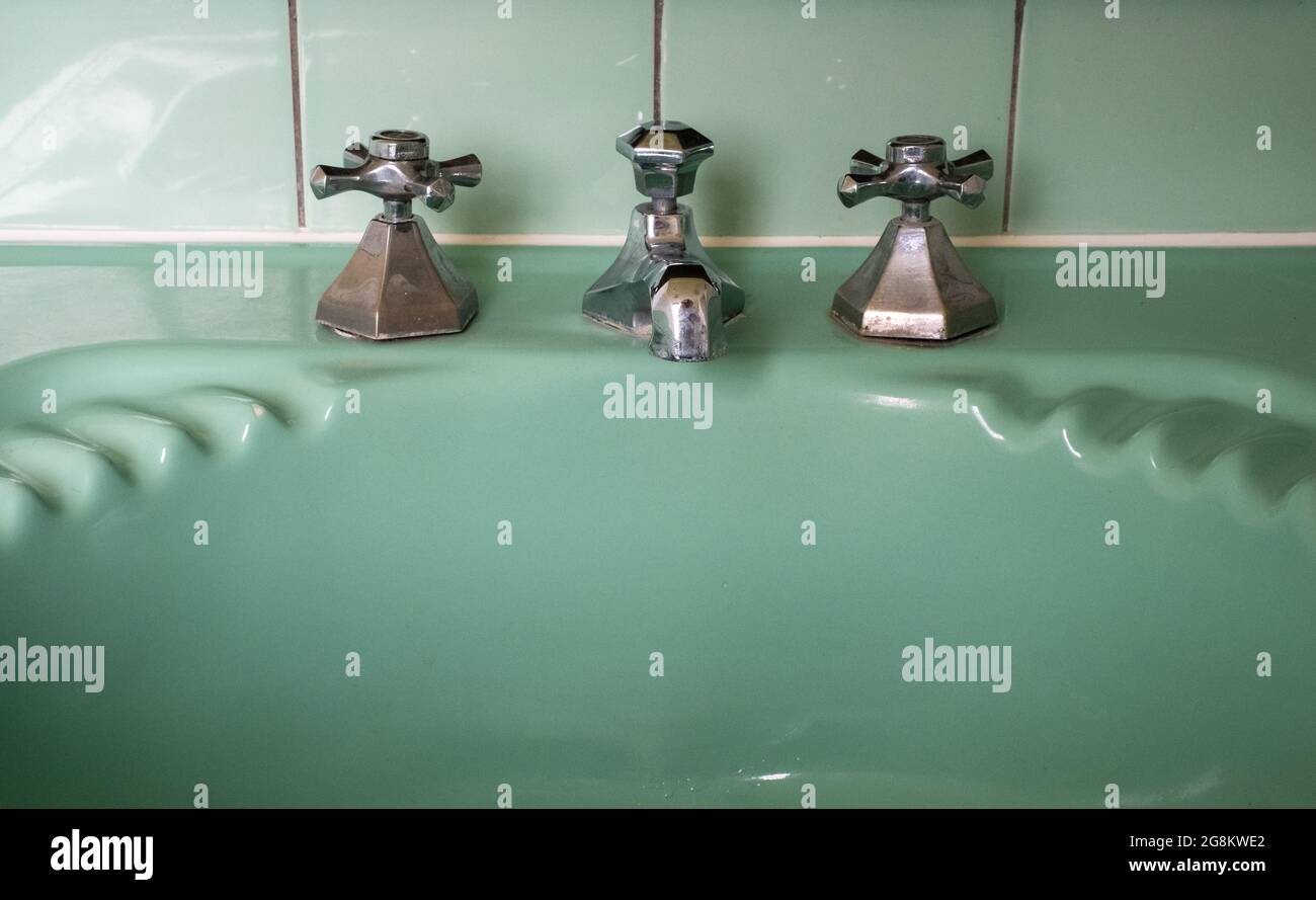 Close up of original green vintage retro 1930s deco wash basin and ...