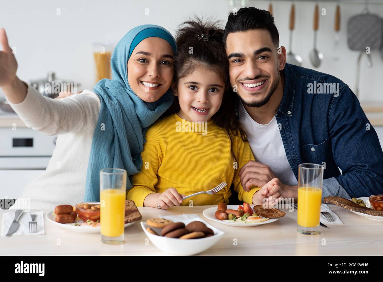 Happy Muslim Family Of Three Taking Selfie While Having Lunch Together ...