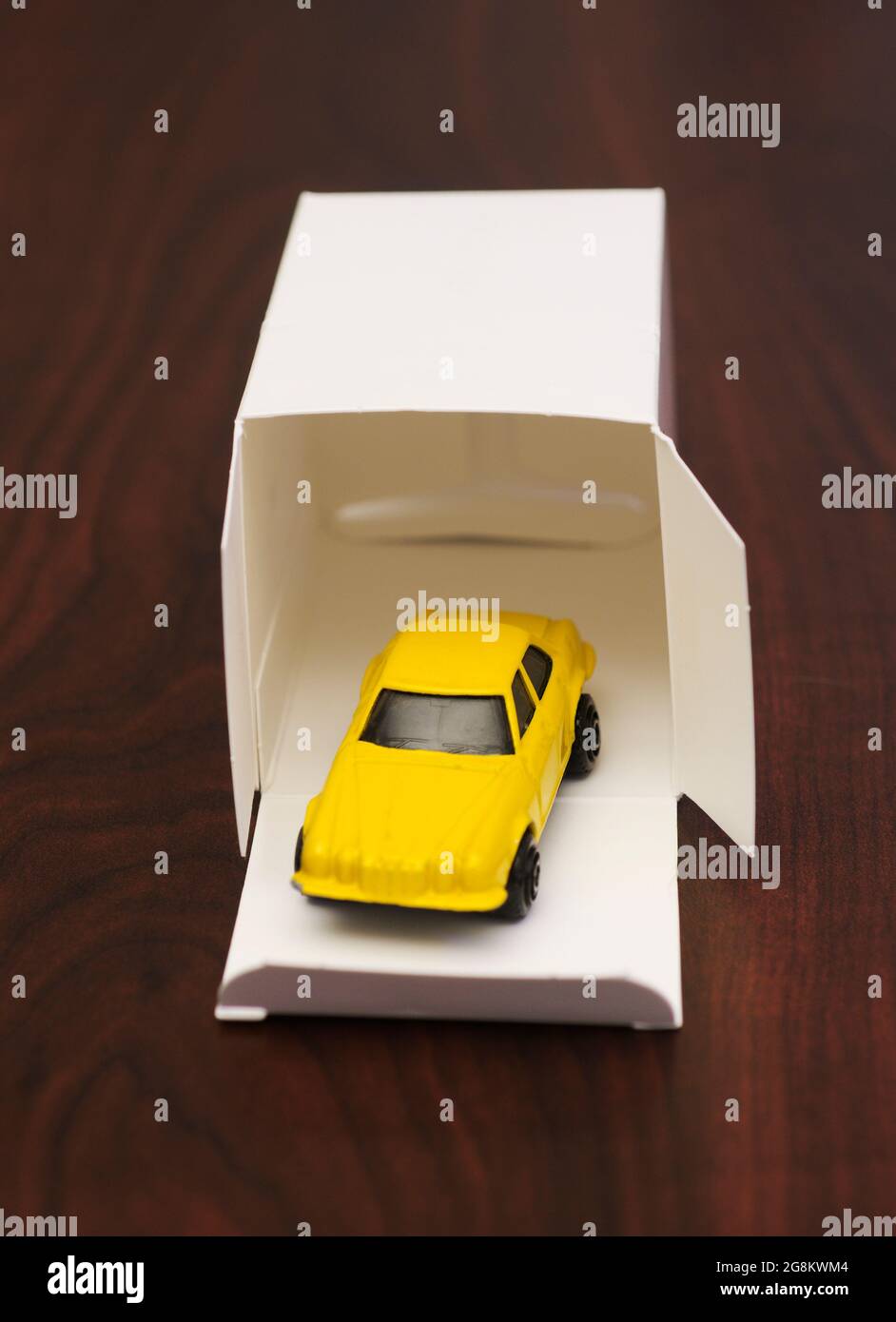 yellow toy car in a cardboard box Stock Photo - Alamy