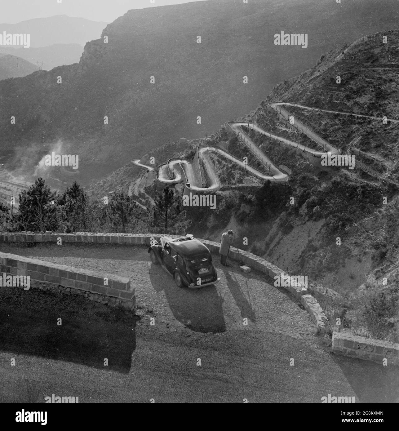 1952, historical, Monaco, a man beside his parked car taking a ...