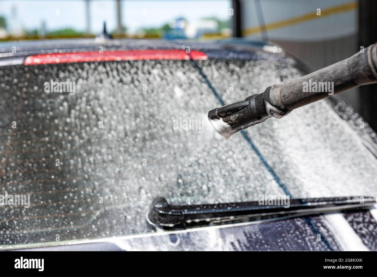 Car wash. The process of washing a car with active foam under pressure ...
