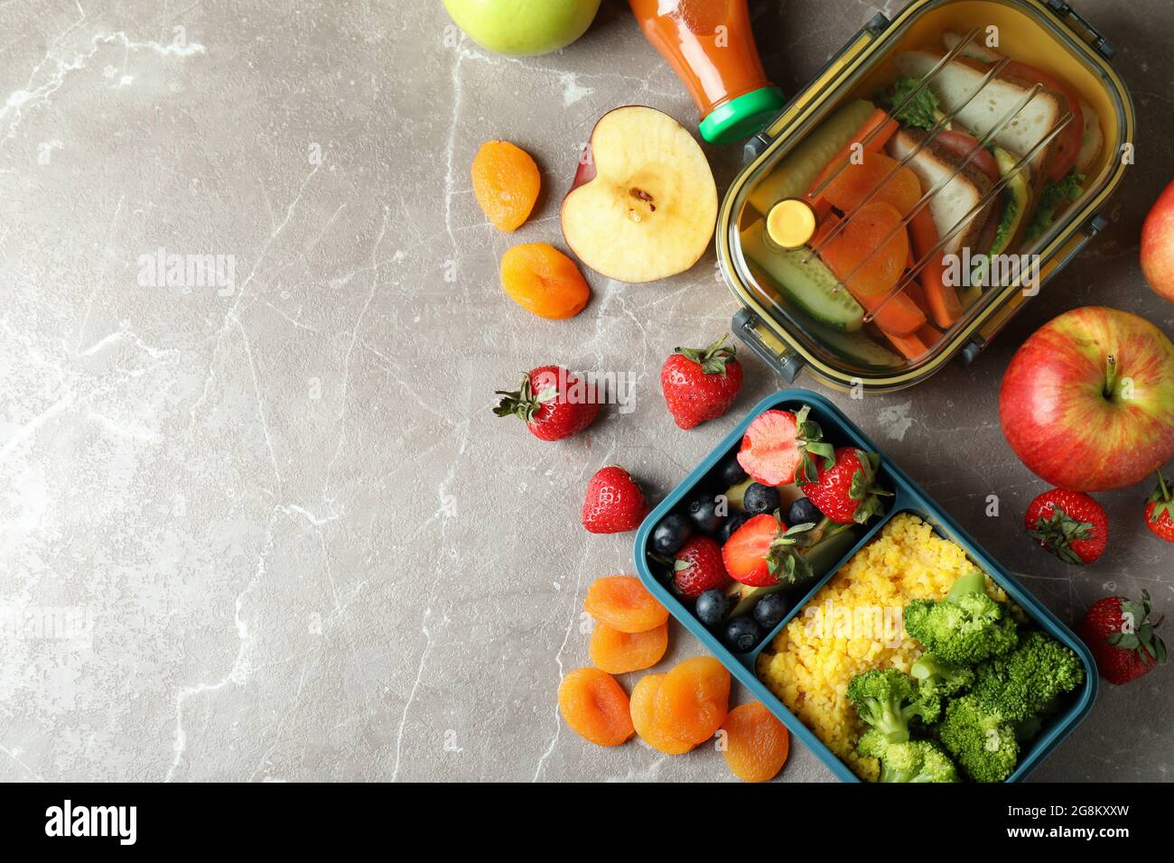 Lunch boxes with tasty food on gray textured table Stock Photo - Alamy