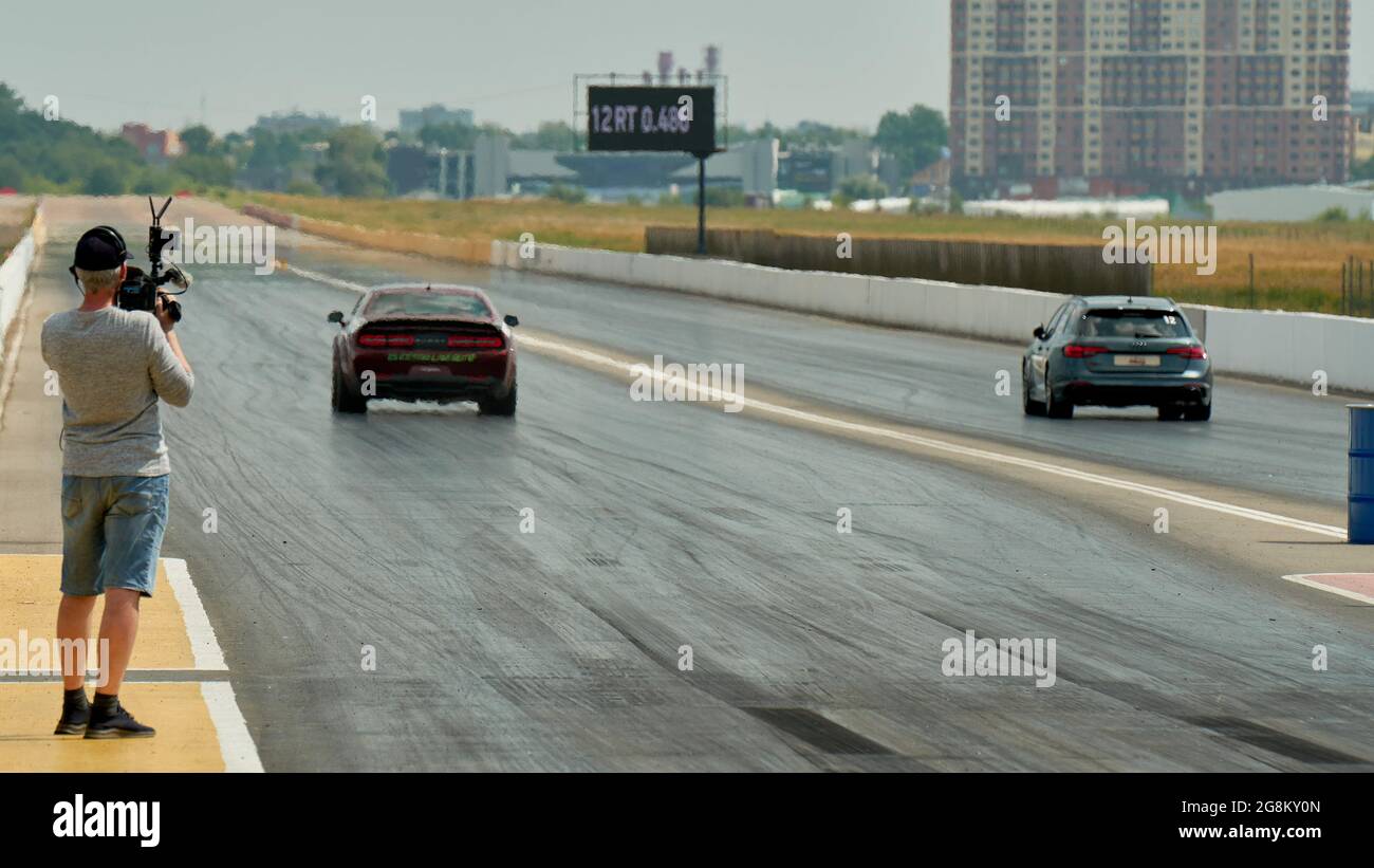 The operator films a report on the "Moscow Mile" supercars race. The ...