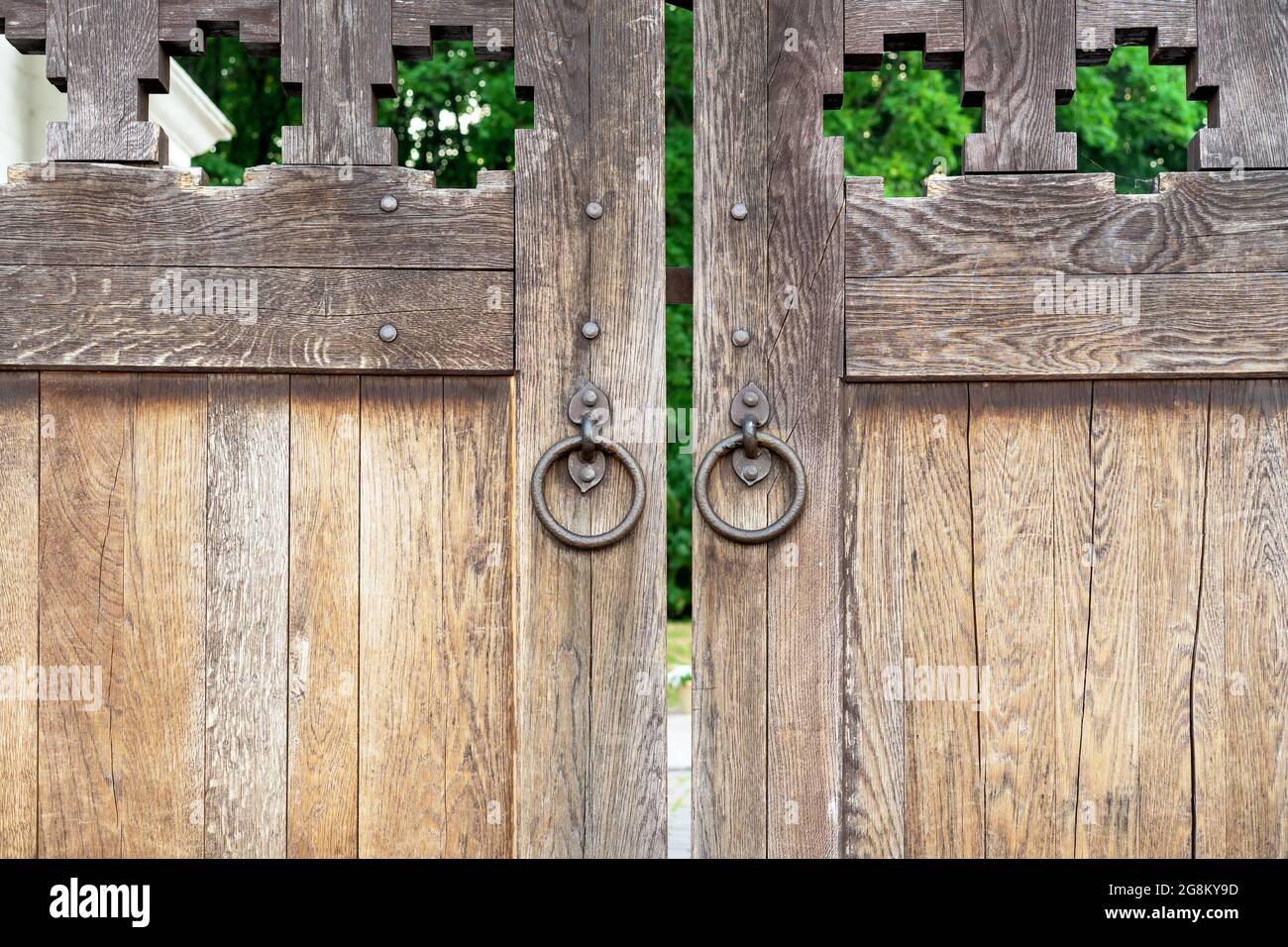Old wooden gate with round forged handles Stock Photo - Alamy