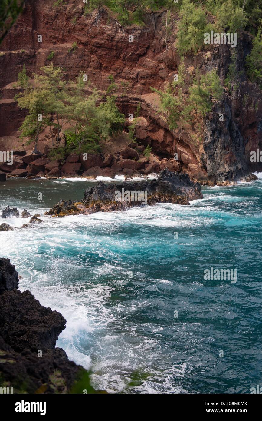 Beautiful ocean beach with large rocks on the shore and in the water ...