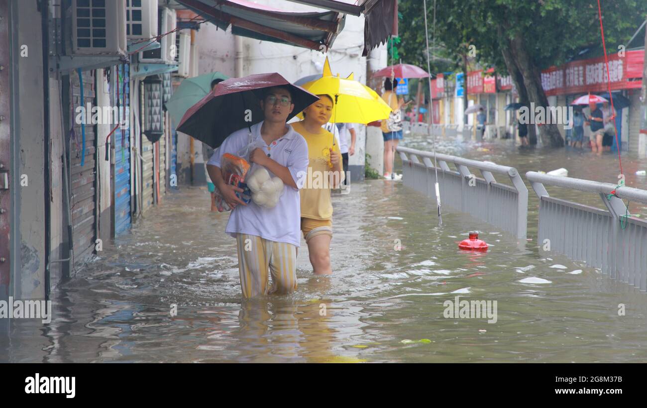 Zhengzhou, China. 21st July, 2021. People try to commute through ...