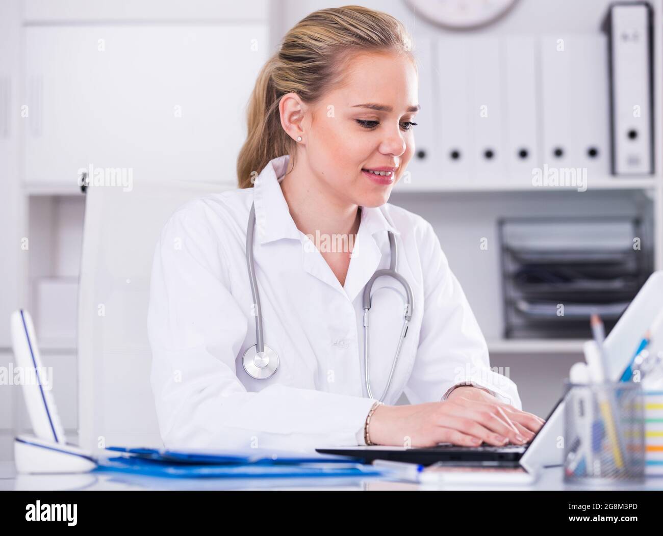 Female doctor working in office Stock Photo - Alamy