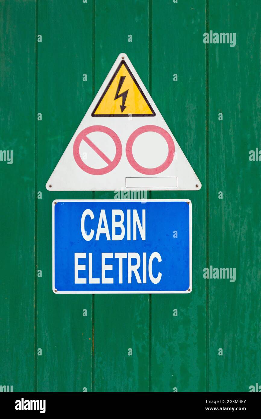 Electrical Hazard Warning Sign at Green Door Stock Photo - Alamy