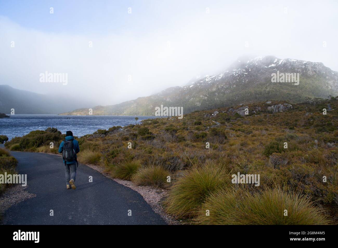 Man walking on path to Cradle Mountain, Tasmania Stock Photo - Alamy