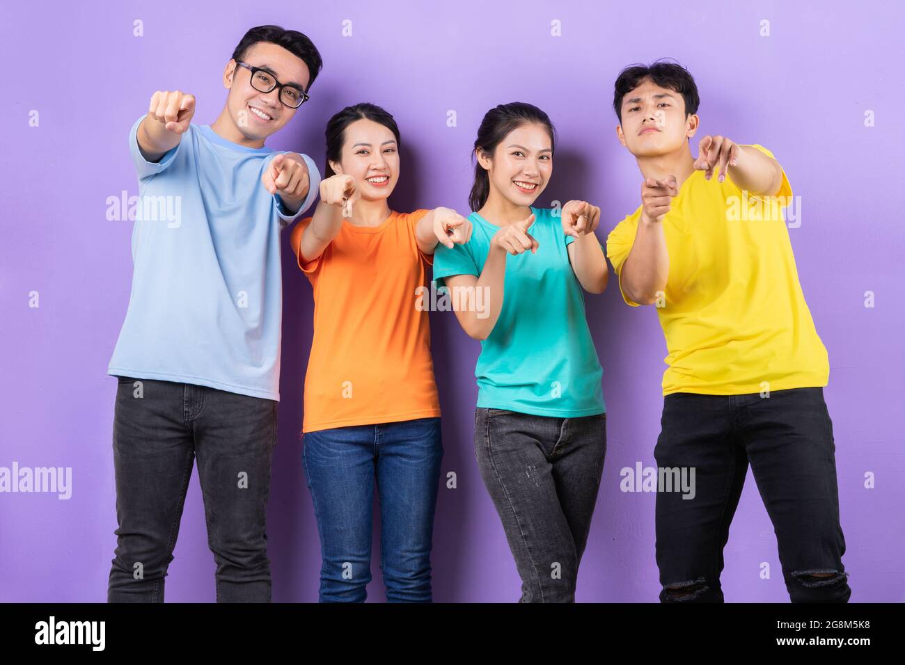 Group of young Vietnamese friends happily pointing at the camera on ...