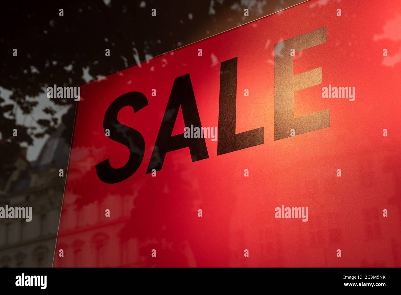 Big Red Sale Sign with european architecture reflected on window glass ...
