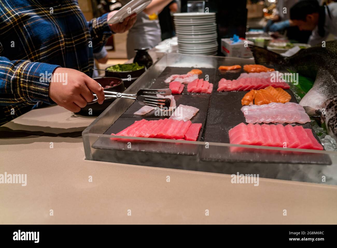 Eating Japanese food with Sashimi, sushi Stock Photo - Alamy