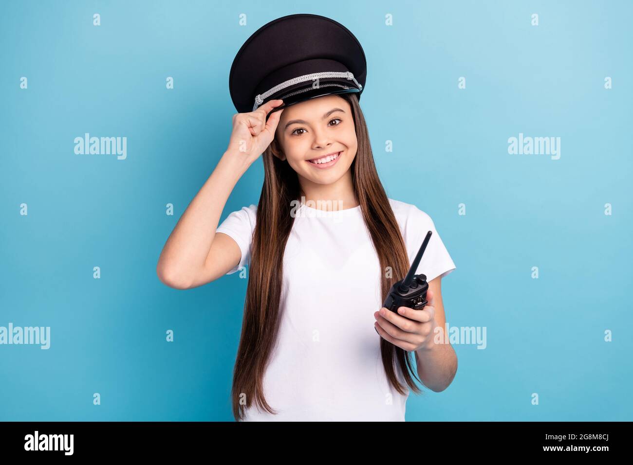 Photo of happy positive smiling little girl in pilot cap hold radio set ...