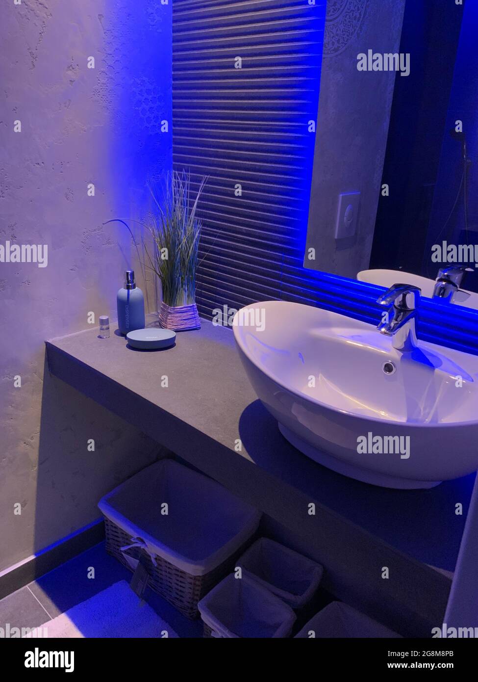 Modern bathroom in blue light Stock Photo - Alamy