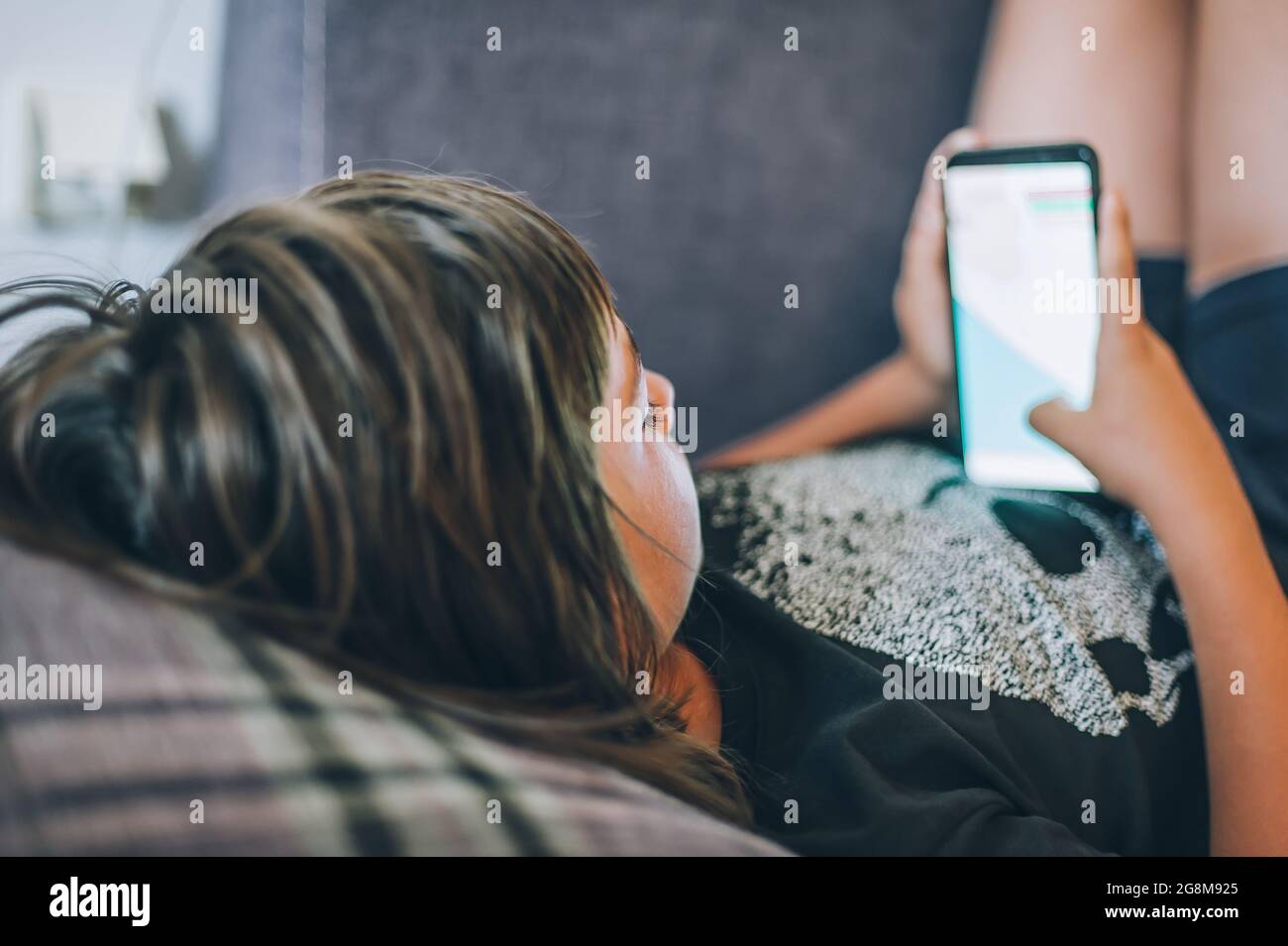 Teen boy checking social media holding smartphone, using mobile phone ...