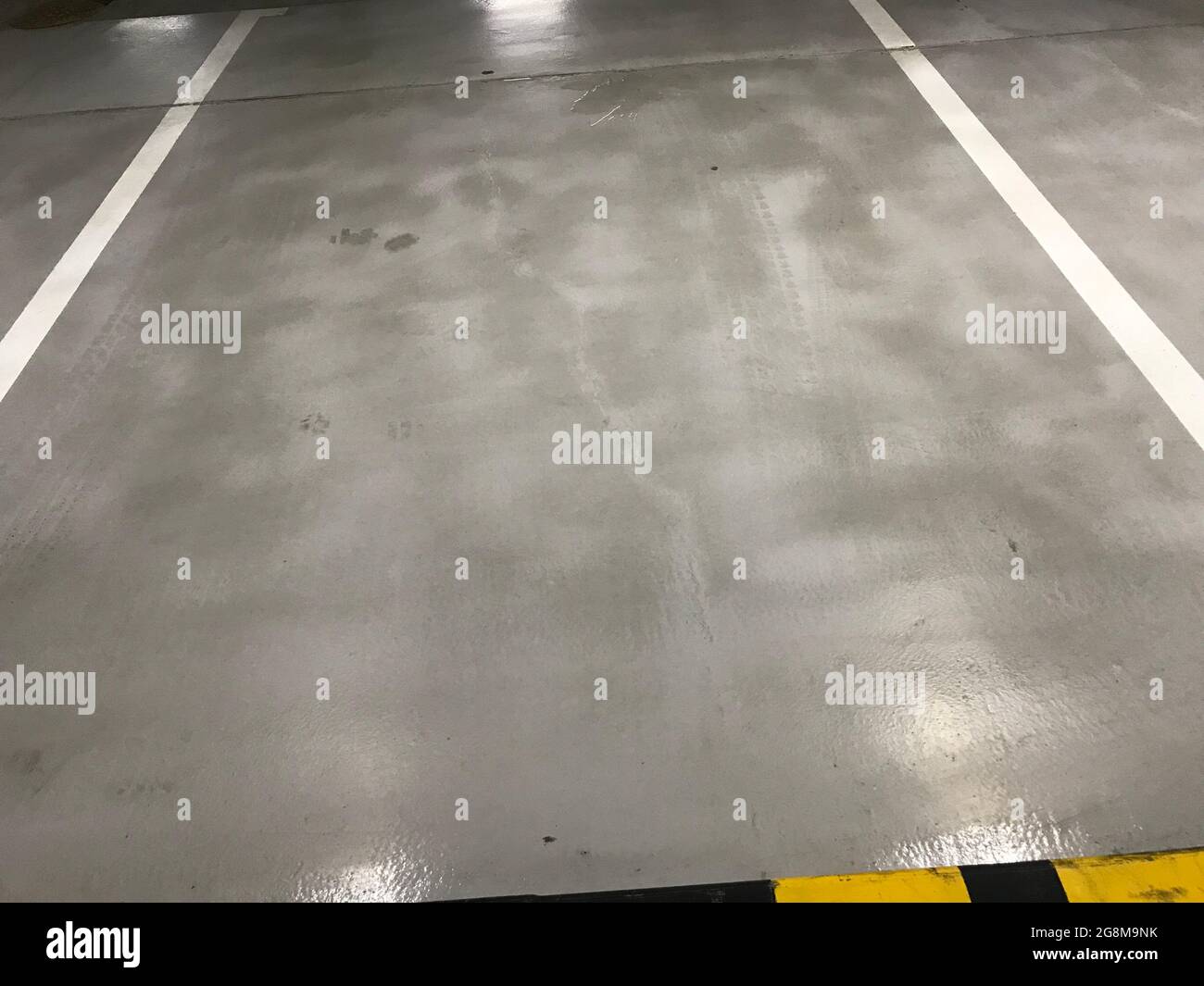 Basement car parking Single car lane separated by two white lines and ...