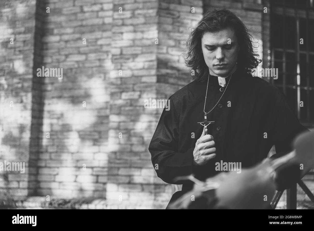 Christian priest with cross standing by the church Stock Photo - Alamy