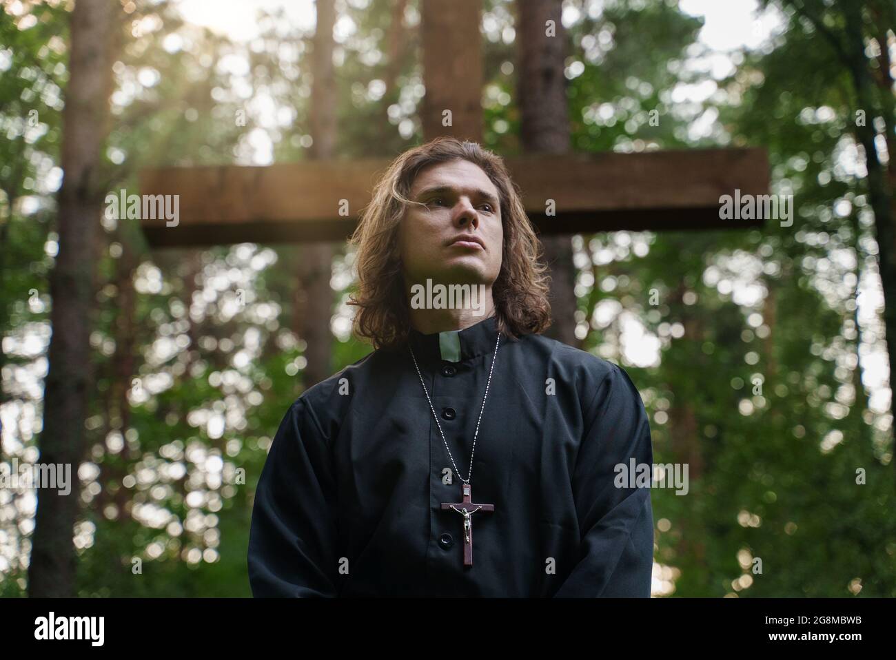 Christian priest with cross on the cemetery Stock Photo - Alamy