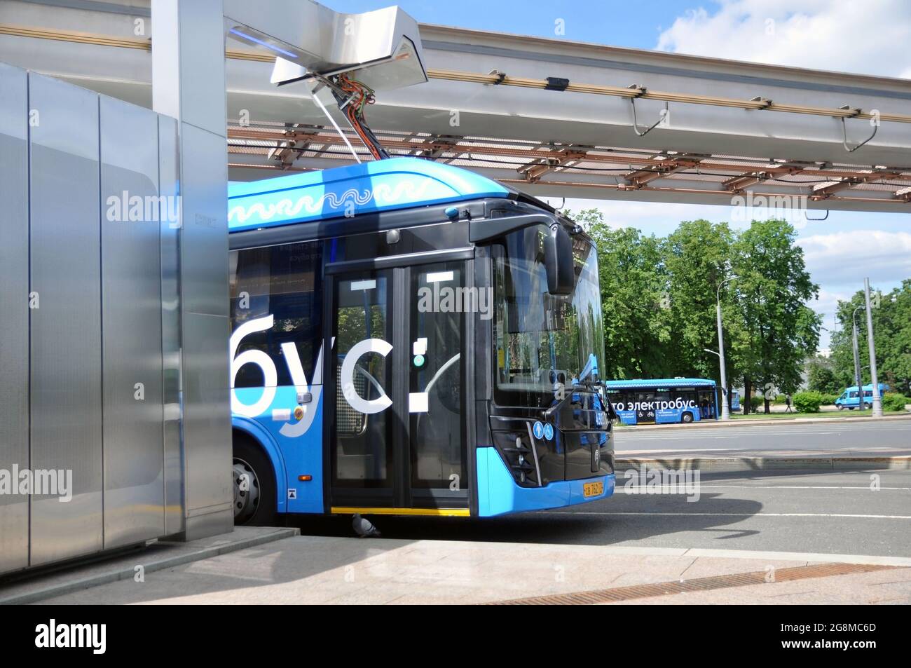 Electric bus at the charging station during recharging. Eco-friendly ...