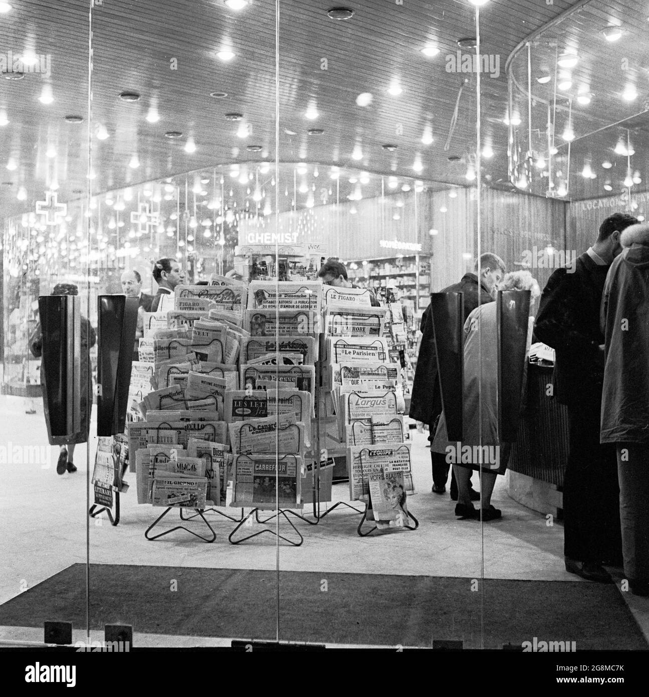 1950s, historical, Evening time and Parisian shoppers browse the goods ...