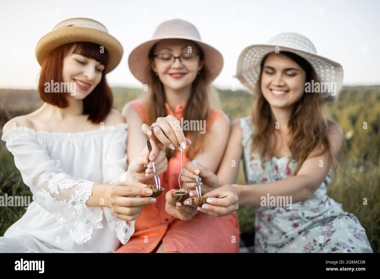 Three gorgeous female friends having fun, enjoy picnic, showing ...