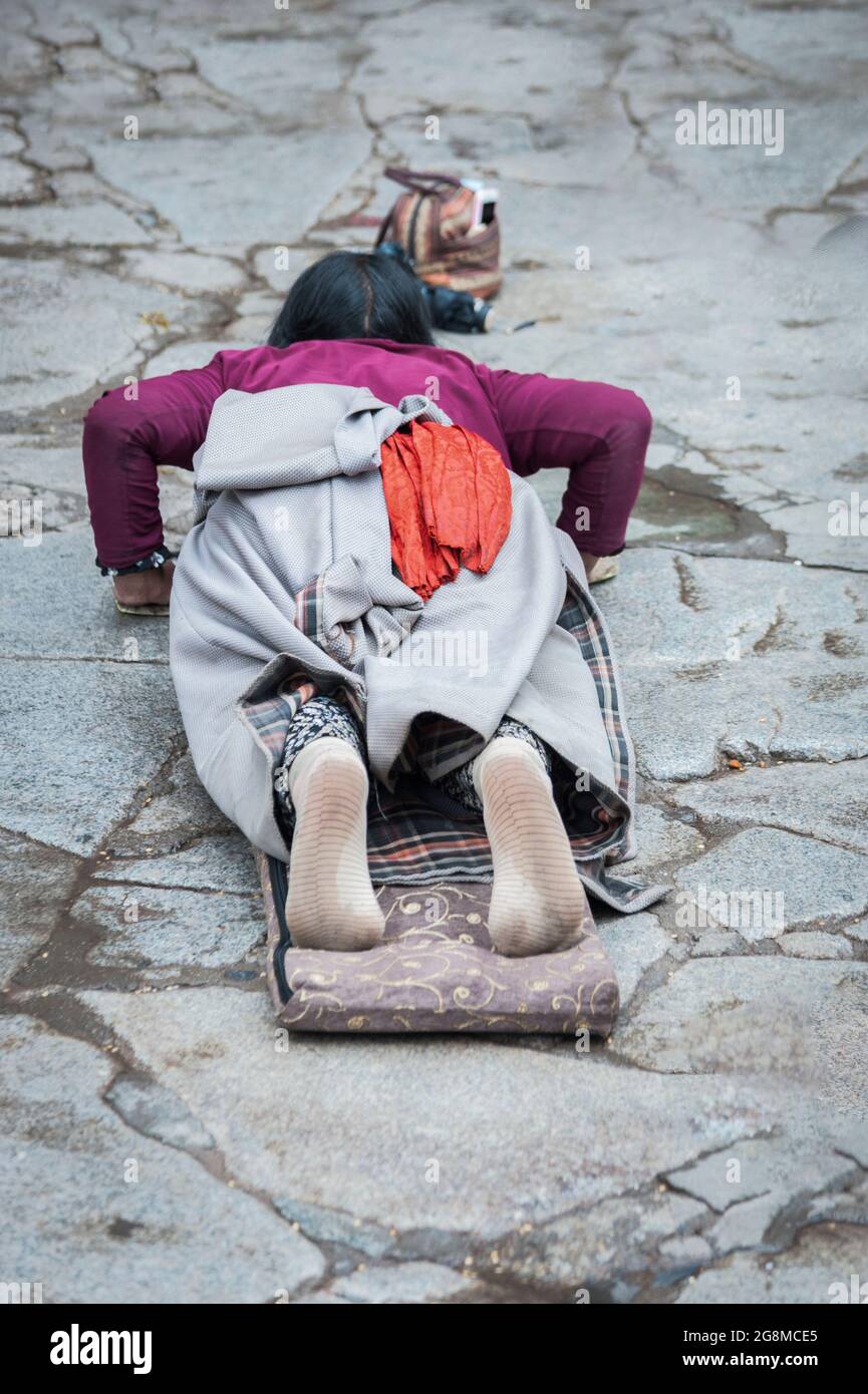Female pilgrim lying on the floor after prostrating herself. Doing the ...