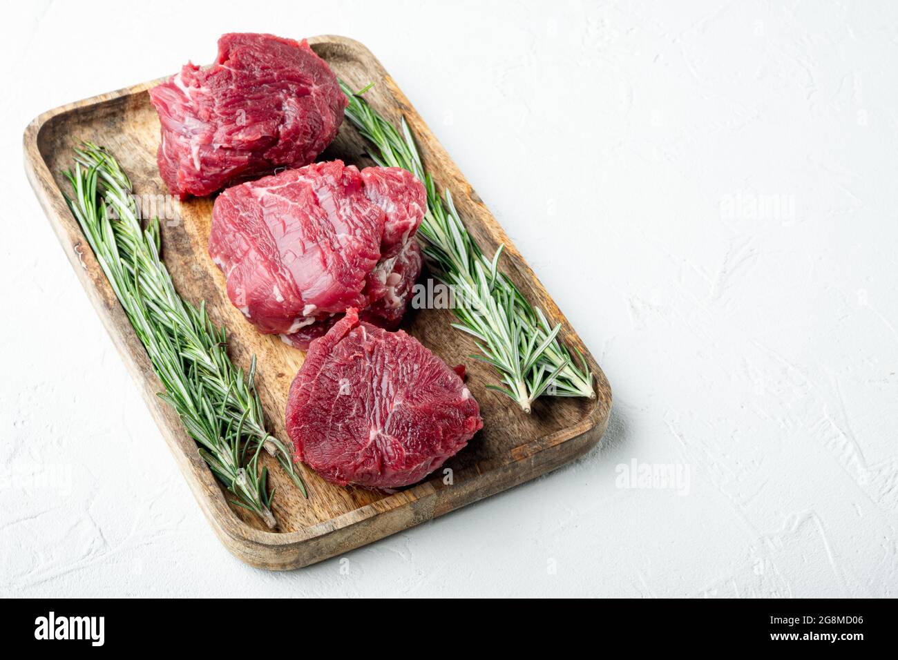 Raw filet mignon or eye steaks with herbs and spices set, on wooden ...