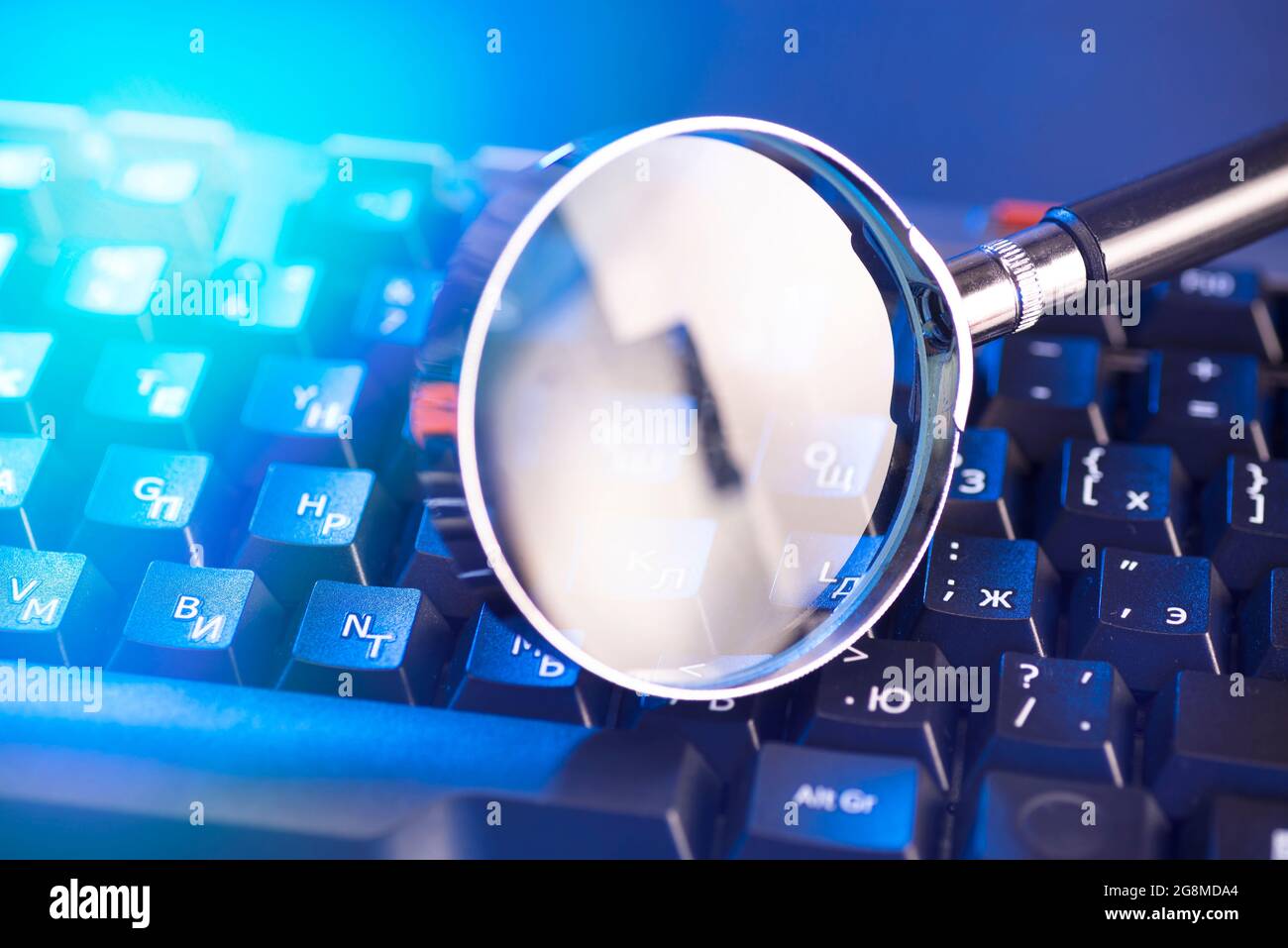 Magnifying glass on the keys of a black computer keyboard Stock Photo ...