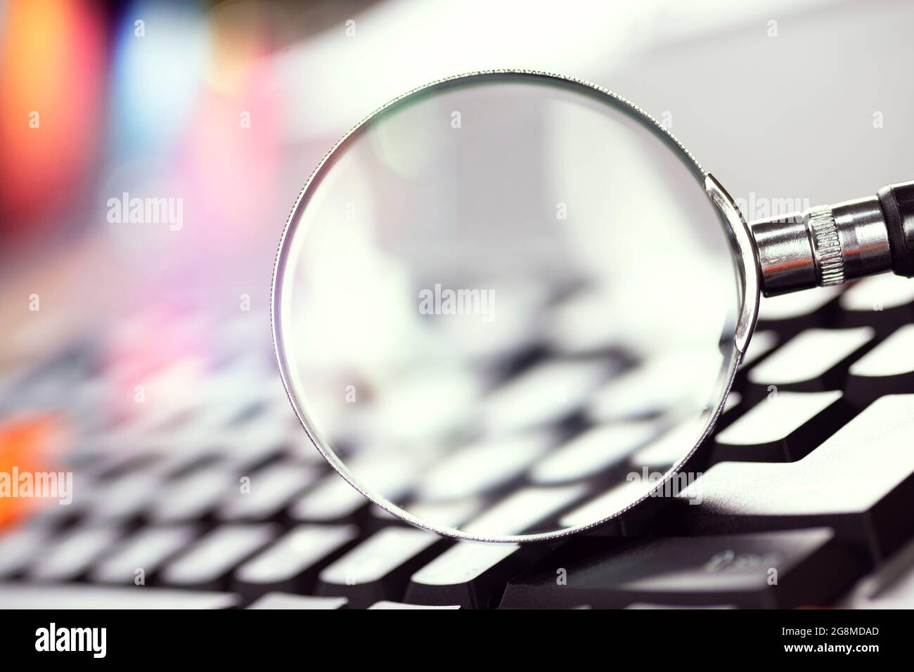 Magnifying glass on the keys of a black computer keyboard Stock Photo ...