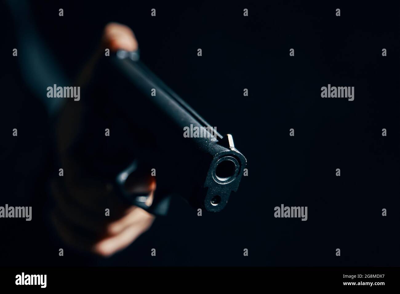 Gun in man's hand on dark background. Firearms close-up. Pistol for ...