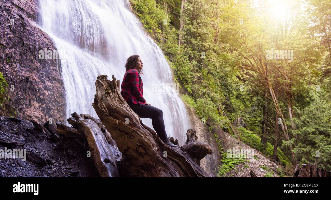 Woman watching the Waterfall in the Canadian rainforest Stock Photo - Alamy