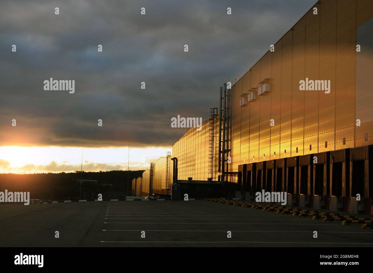 Warehouse logistics complex in the rays of the rising sun Stock Photo ...