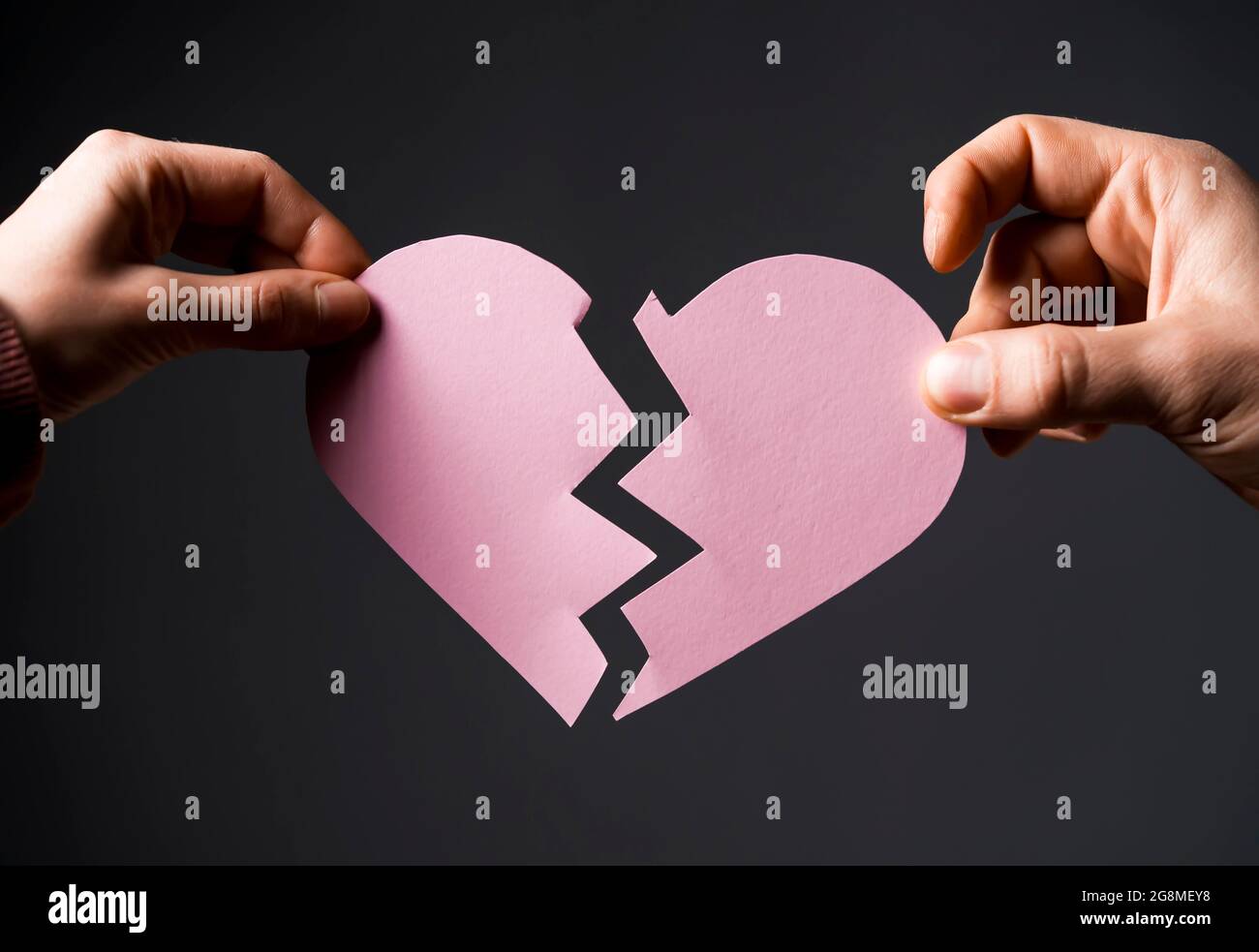 Male and female hands pull the heart in different directions Stock ...