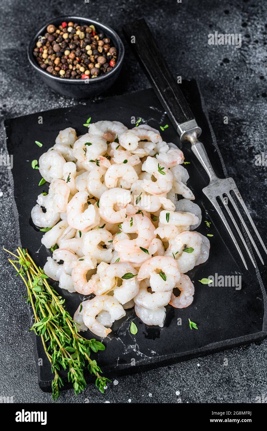 Peeled Shrimps, Prawns on a marble board. Black background. top view ...