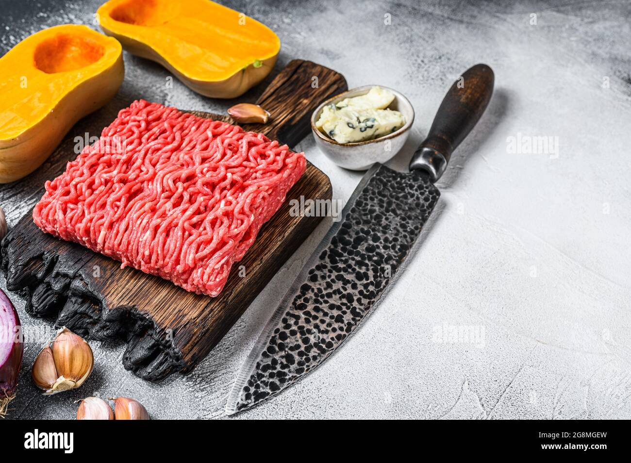 Raw mince meat, pumpkin with garlic and onion. White background. Top ...