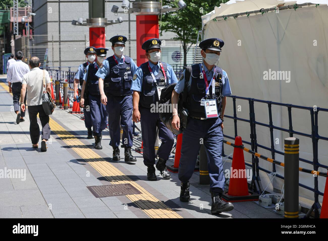Tokyo, Japan. 21st July, 2021. Police officers on patrol guarding the ...